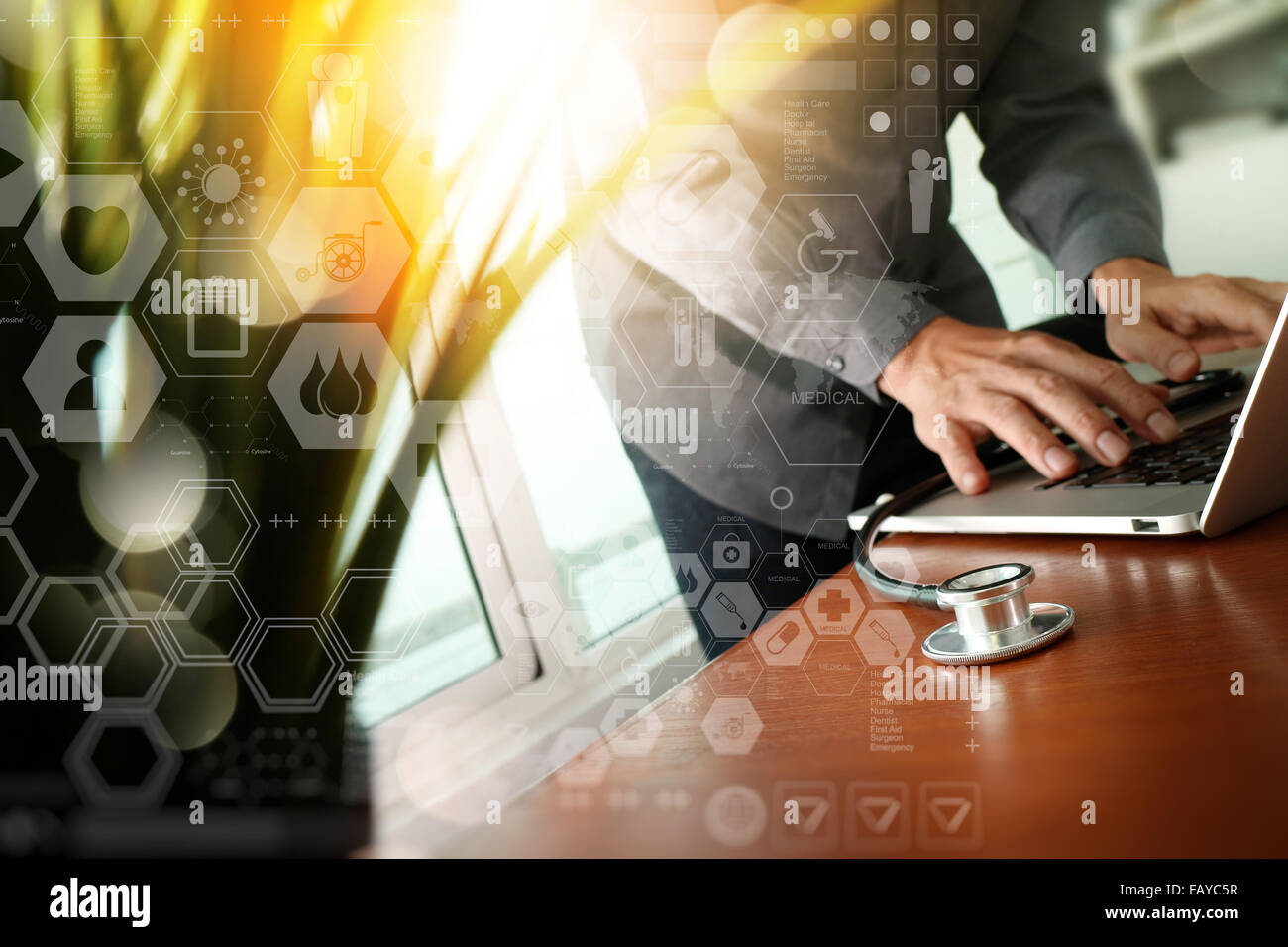 Doctor working at workspace with laptop computer in medical workspace ...