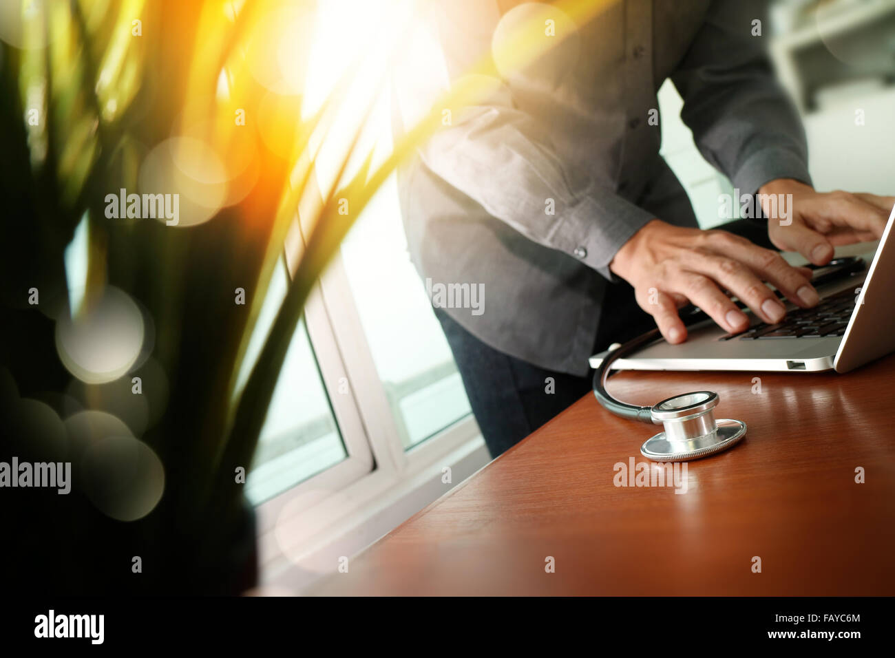Doctor working at workspace with laptop computer in medical workspace ...