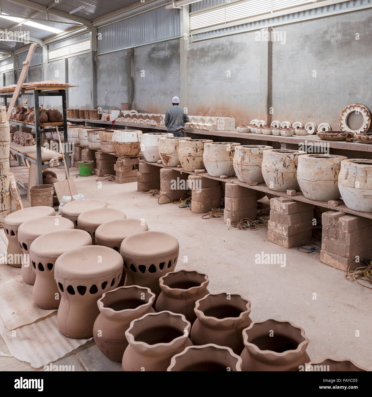Clay pottery in a row in a warehouse; Dolores Hidalgo, Guanajuato ...