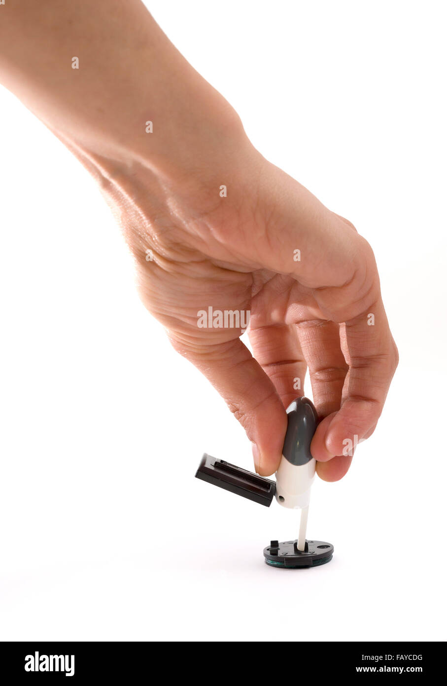 Plastic stamp in hand, isolated on white Stock Photo - Alamy