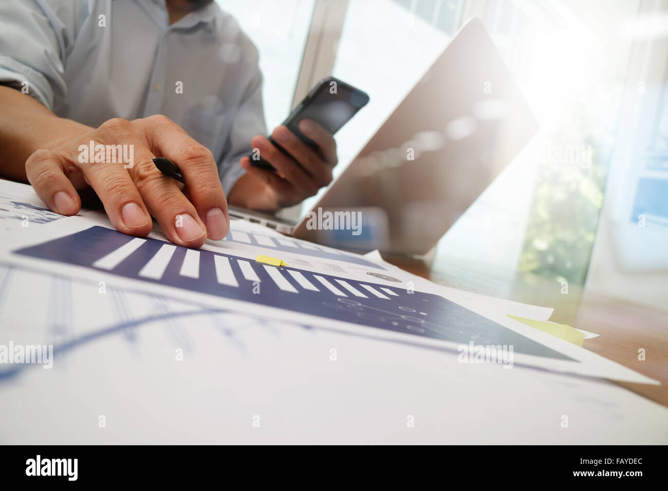 business documents on office table with smart phone and laptop computer ...