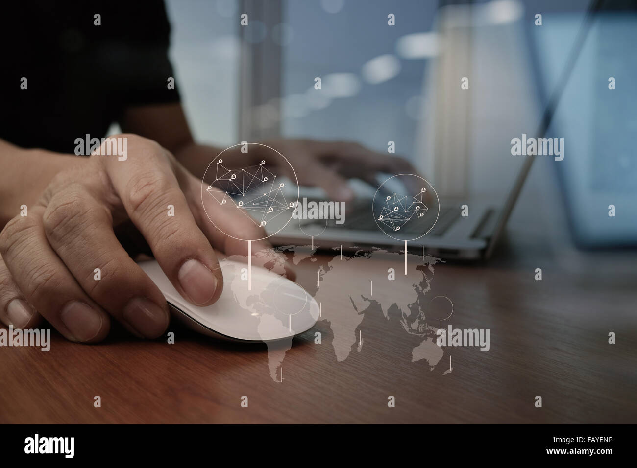 close up of business man hand working on laptop computer on wooden desk ...