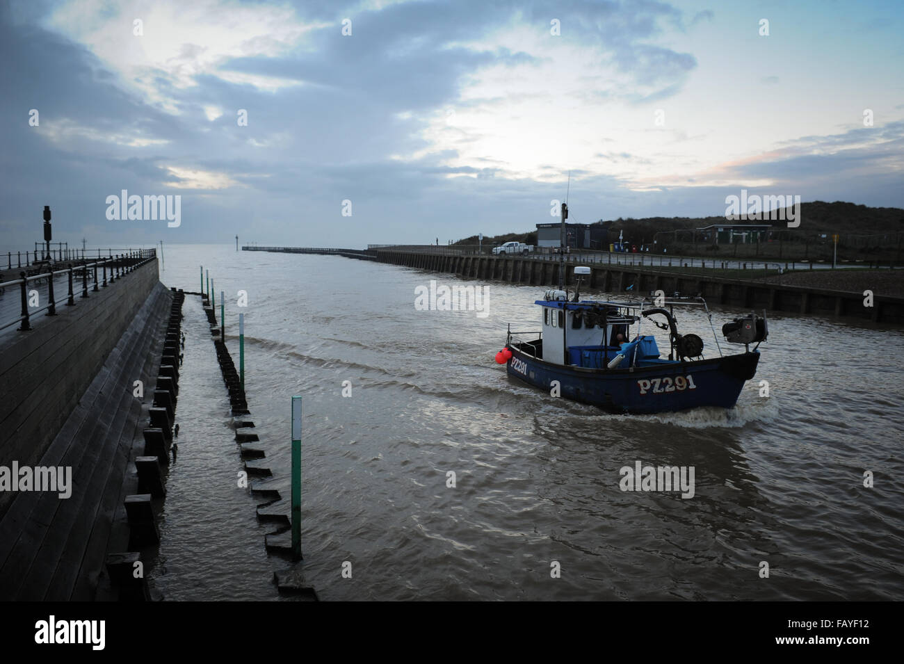 A fishing boat returns into Littlehampton Harbour in the seaside town ...