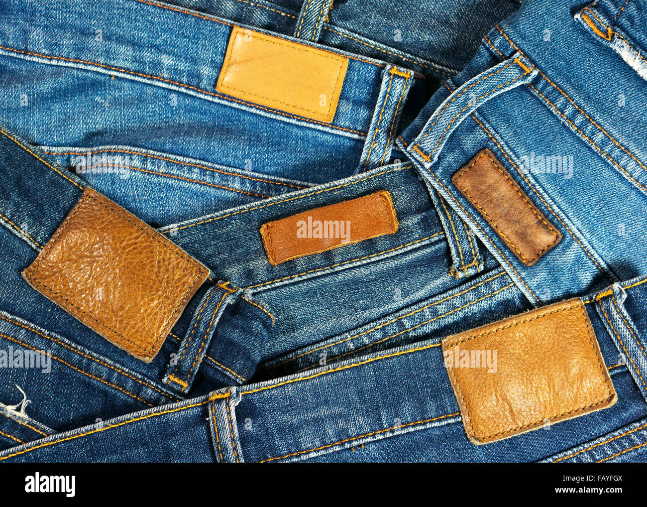 Jeans with brown leather labels texture and background Stock Photo - Alamy