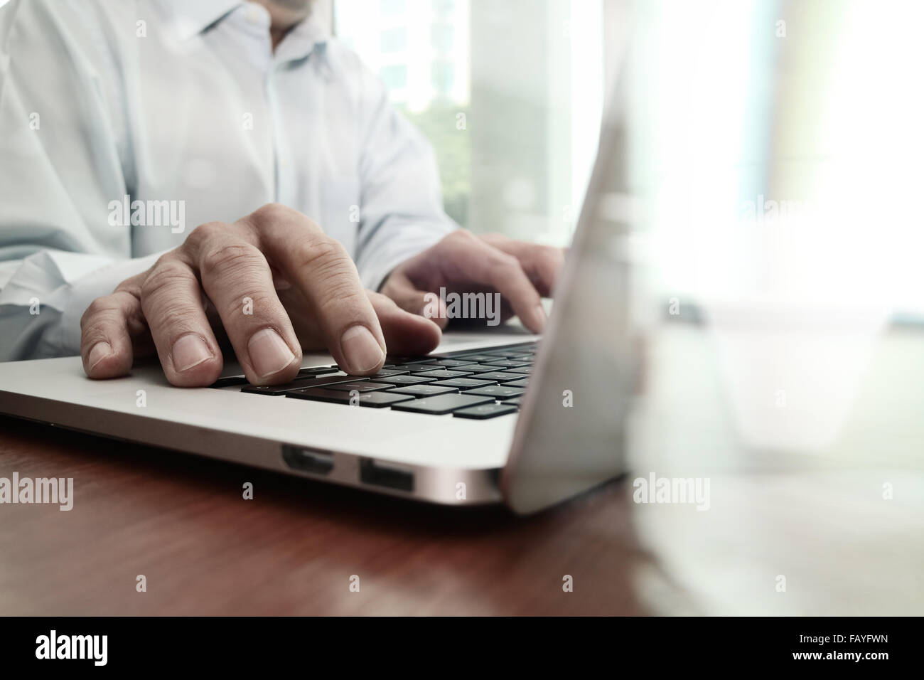 close up of business man hand working on laptop computer with social ...