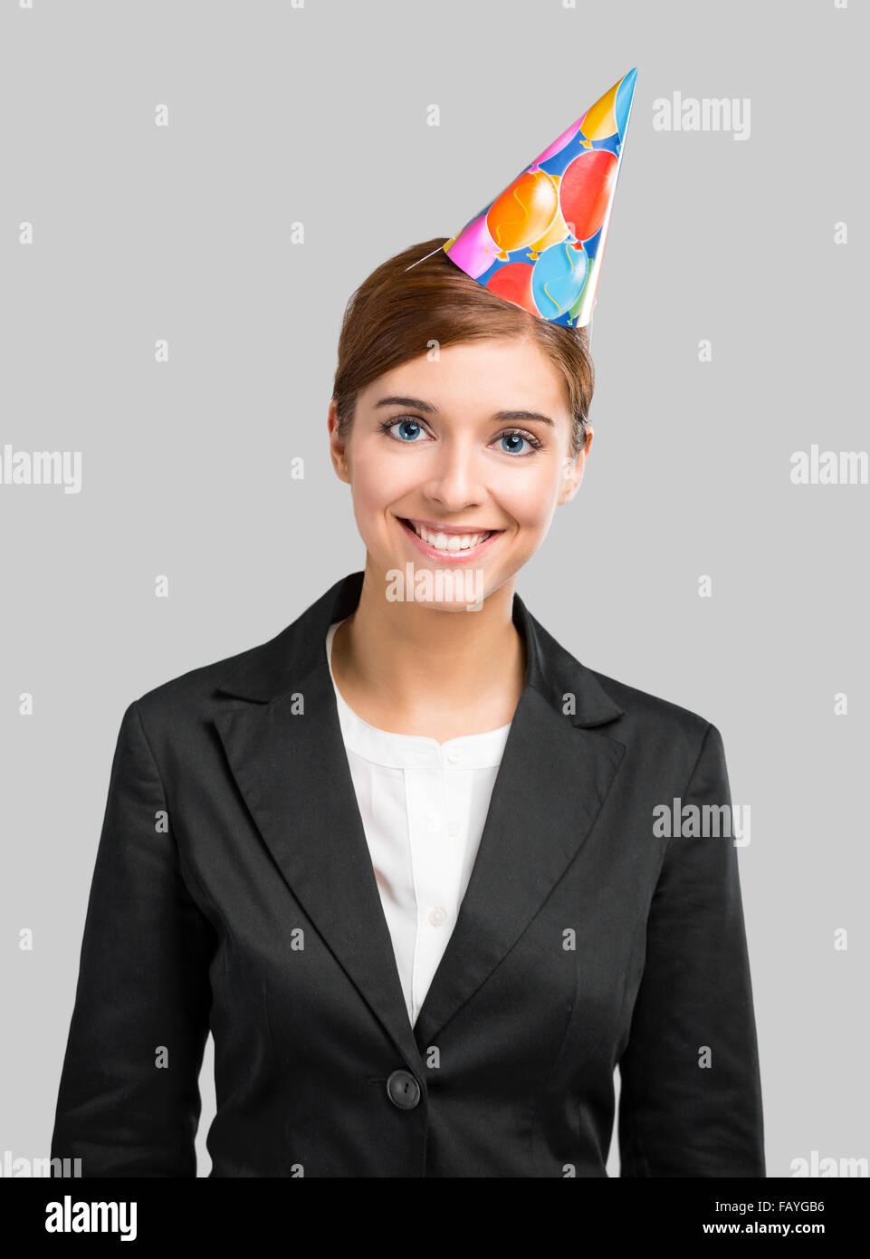 Portrait of a business woman celebrating something with a birthday hat ...