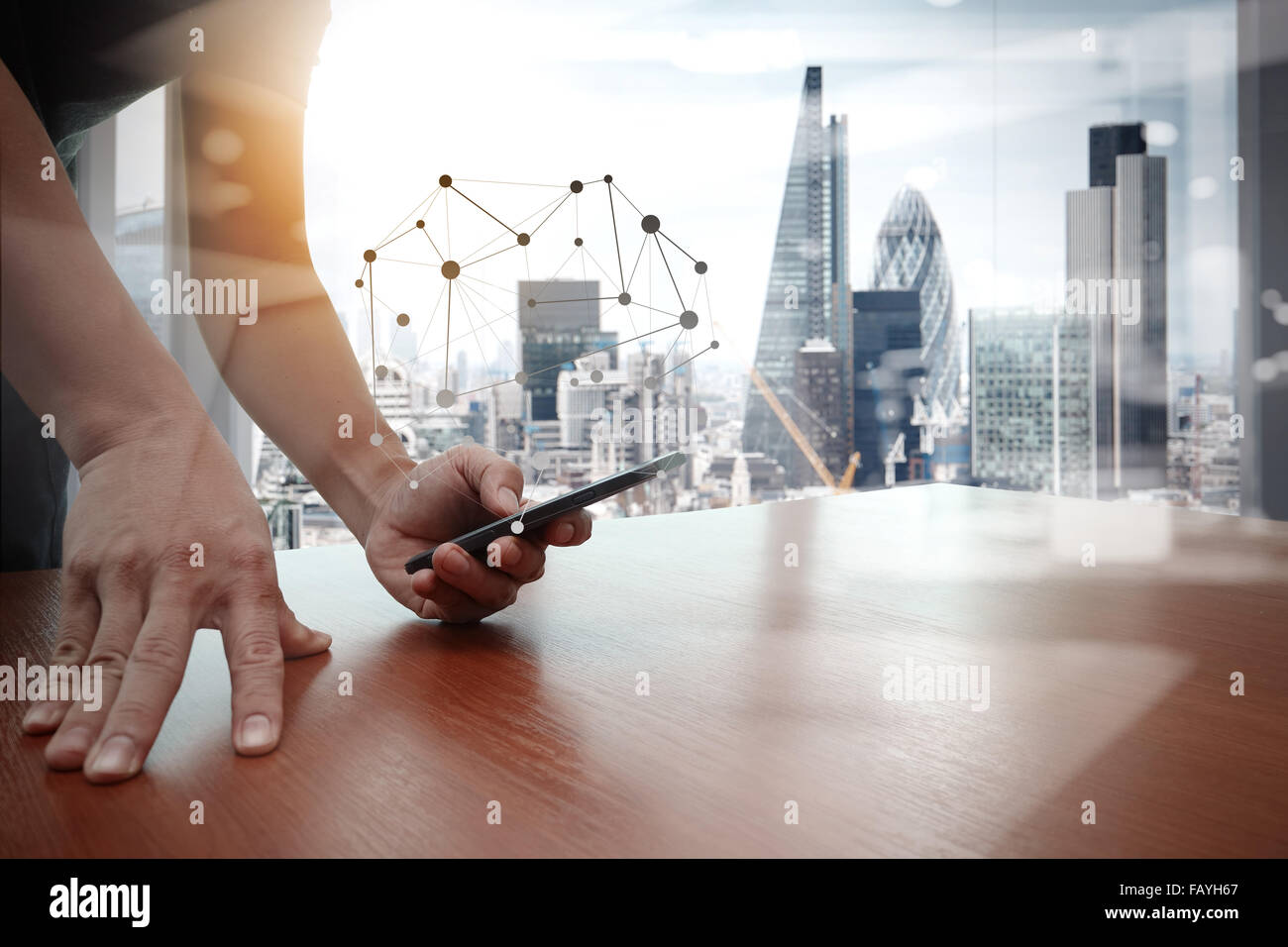 designer hand working and smart phone and laptop on wooden desk in ...