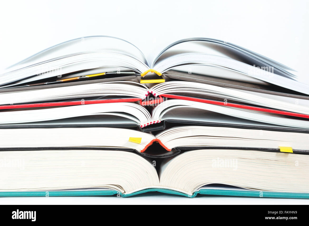 Stack of open books with colorful book covers Stock Photo - Alamy