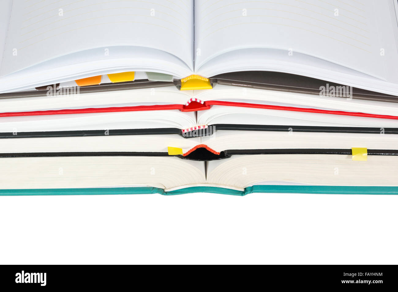Stack of open books with notebook on top isolated on white background ...
