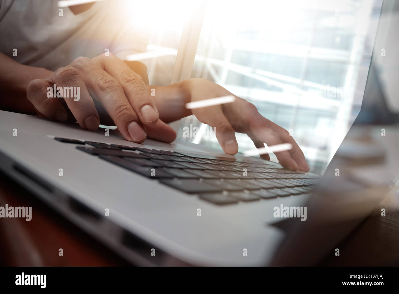 business man hand working on laptop computer on wooden desk as concept ...
