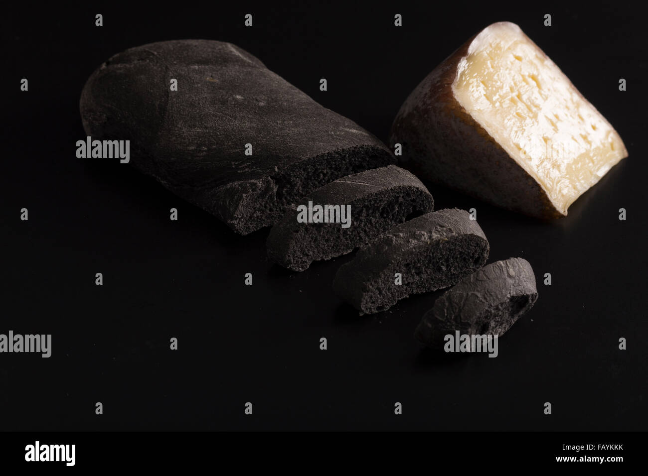 Black italian bread with vegetable carbon and a slice of cheese Stock ...