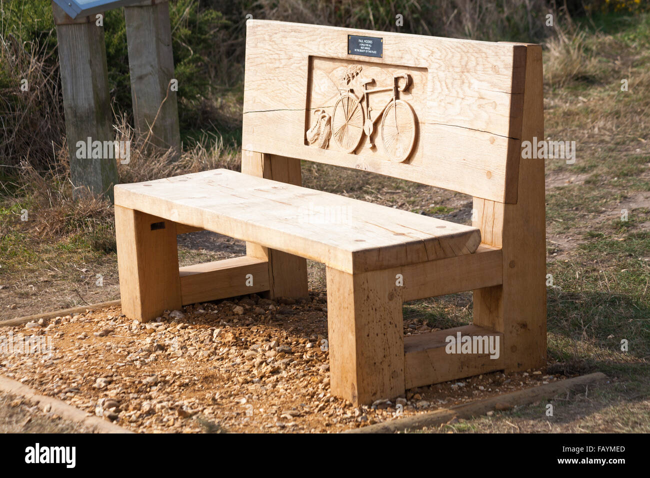 Carved bicycle and boots on wooden bench & plaque Paul Moores a smile ...