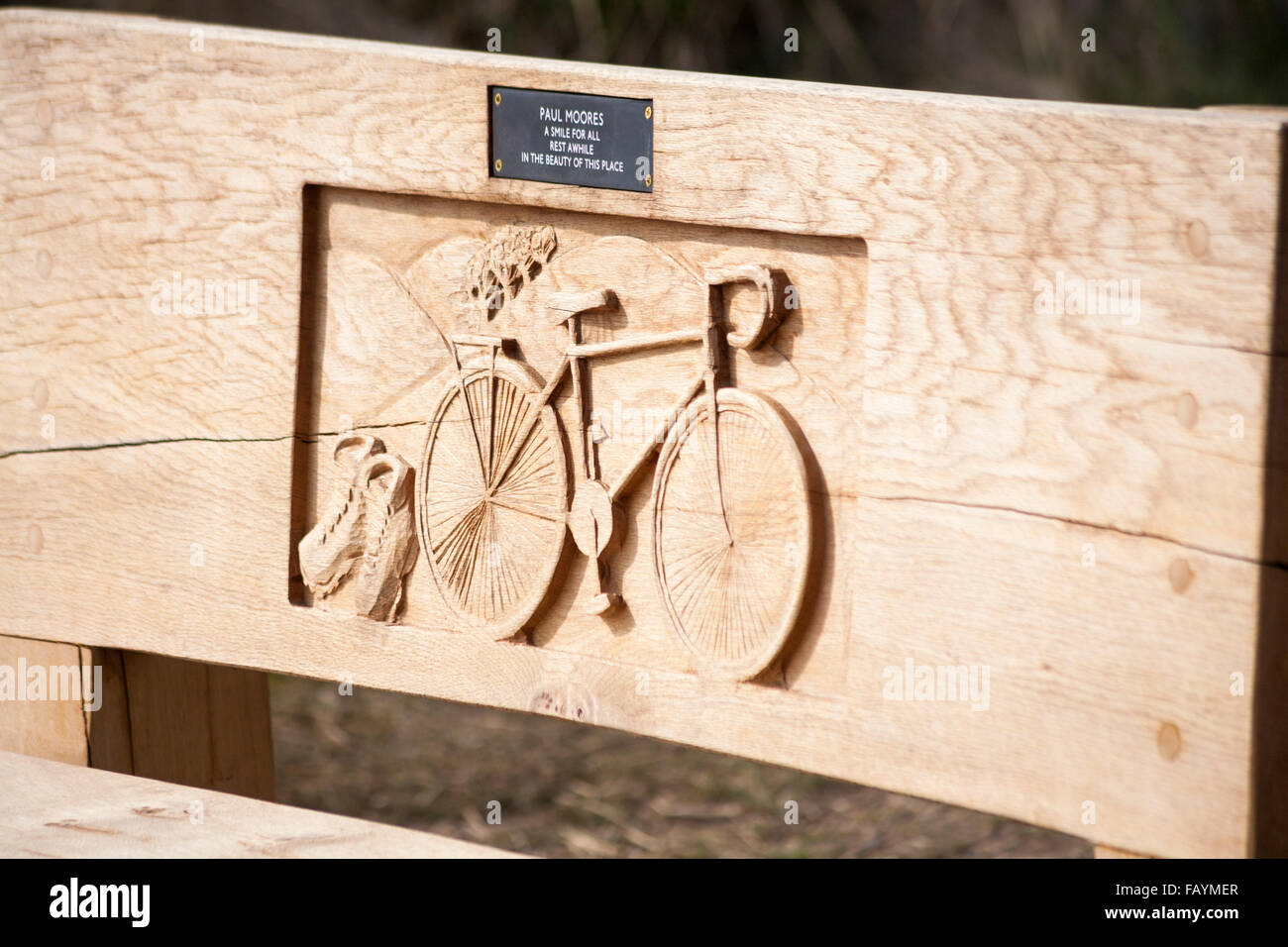 Carved bicycle and boots on wooden bench & plaque Paul Moores a smile ...