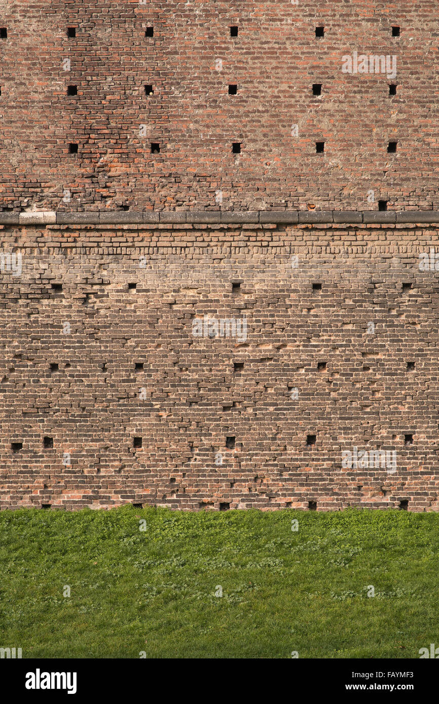 Medieval brick wall texture and green grass Stock Photo - Alamy