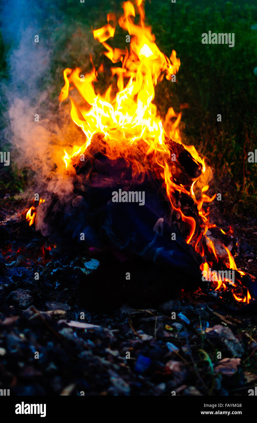 Burning objects in the village in evening time Stock Photo - Alamy