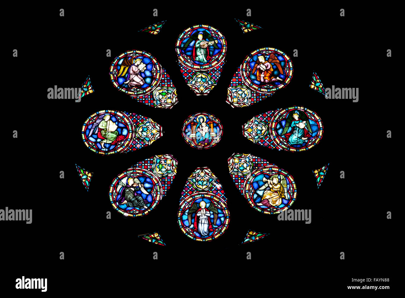 Stained glass rose window with saint Mary and baby Jesus, surrounded by ...
