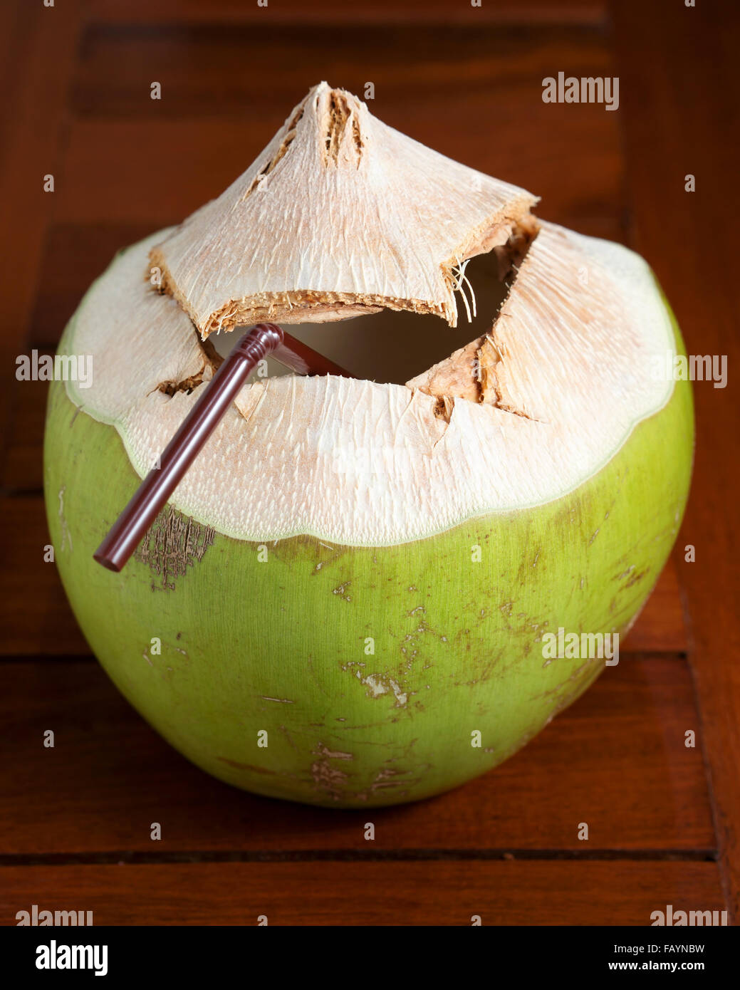 Coconut water drink on wood table Stock Photo - Alamy