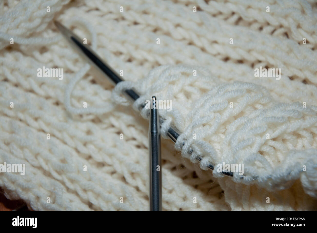 White wool scarf and knitting needle. Knit work Stock Photo - Alamy