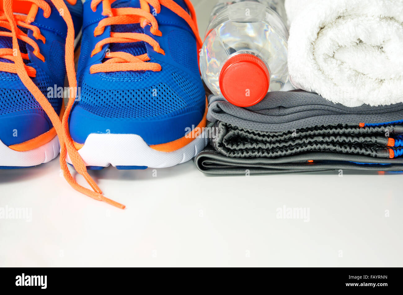 Fitness accessories with running shoes, sport clothing, drinking water ...