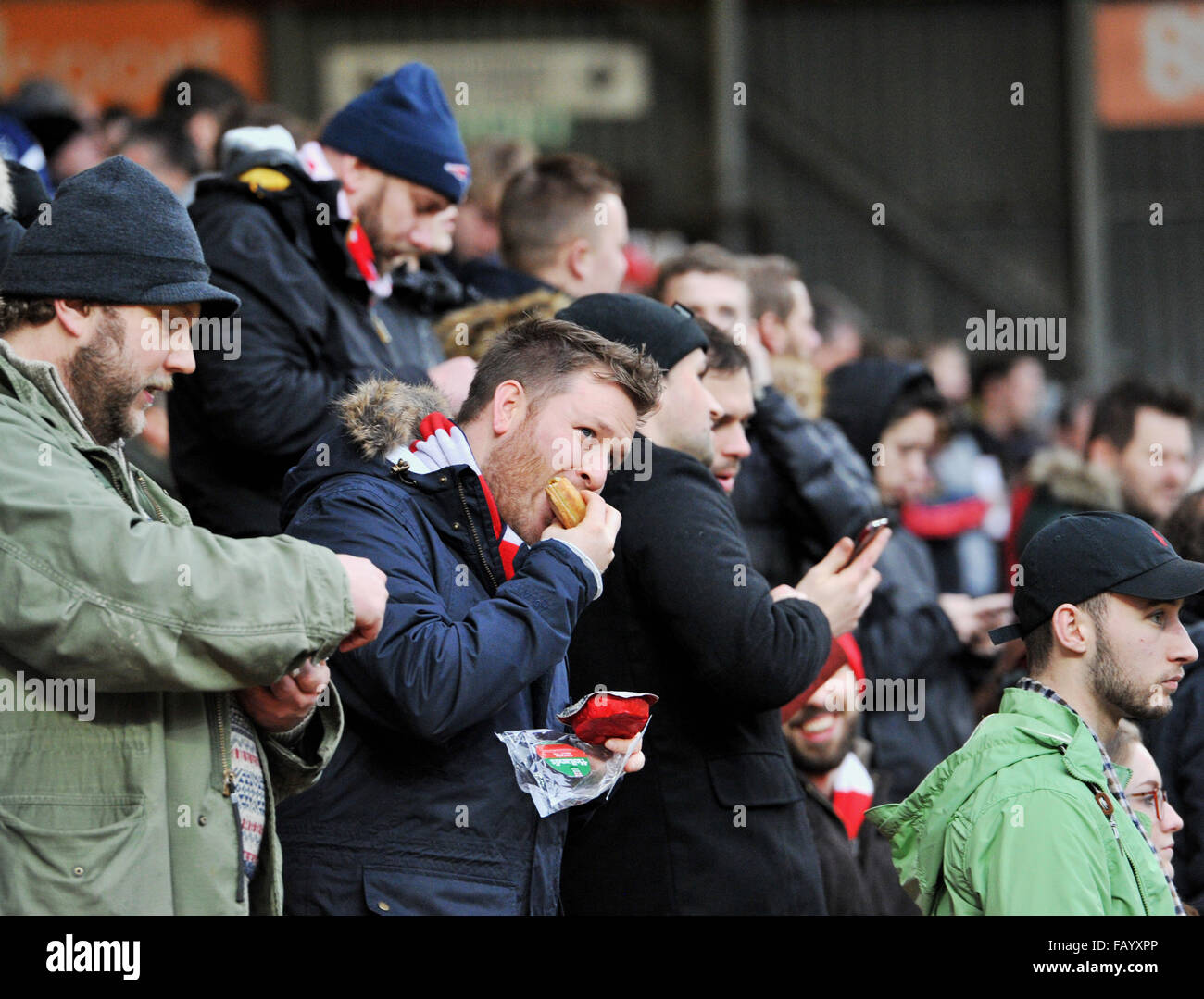 Football fan eating a pie at a Championship match UK Stock Photo - Alamy