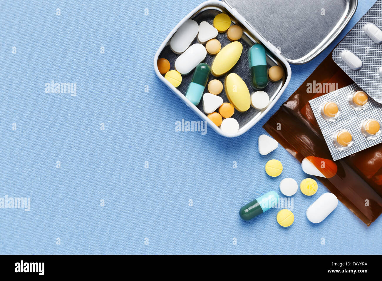 Pills in box and medicine bag on blue fabric background Stock Photo - Alamy