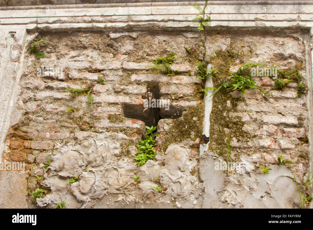 Cross in side of decaying brick crypt in iconic Recoleta Cemetery ...
