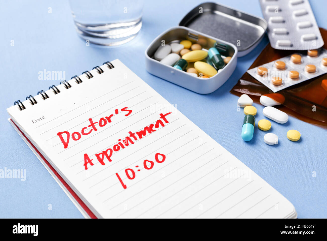 Doctor appointment note with medicine pills on table Stock Photo - Alamy