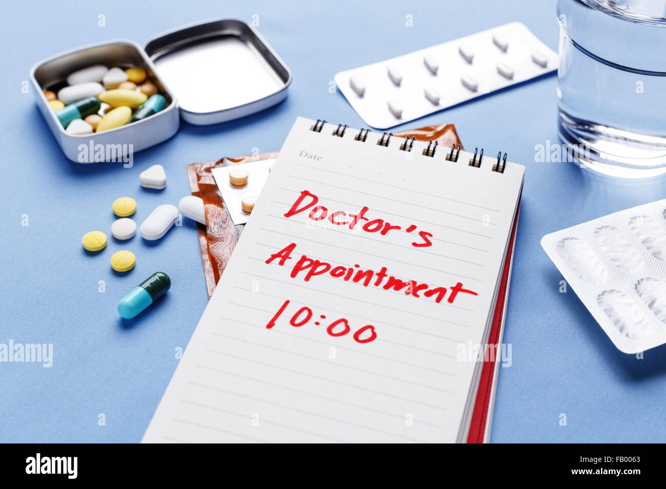 Doctor appointment note with pills on table Stock Photo - Alamy