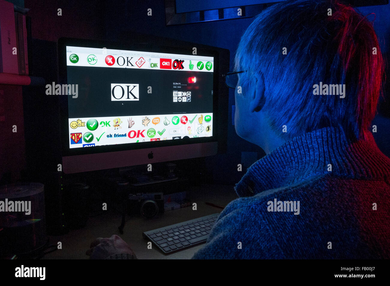Man at computer with 'OK' written on screen Stock Photo - Alamy