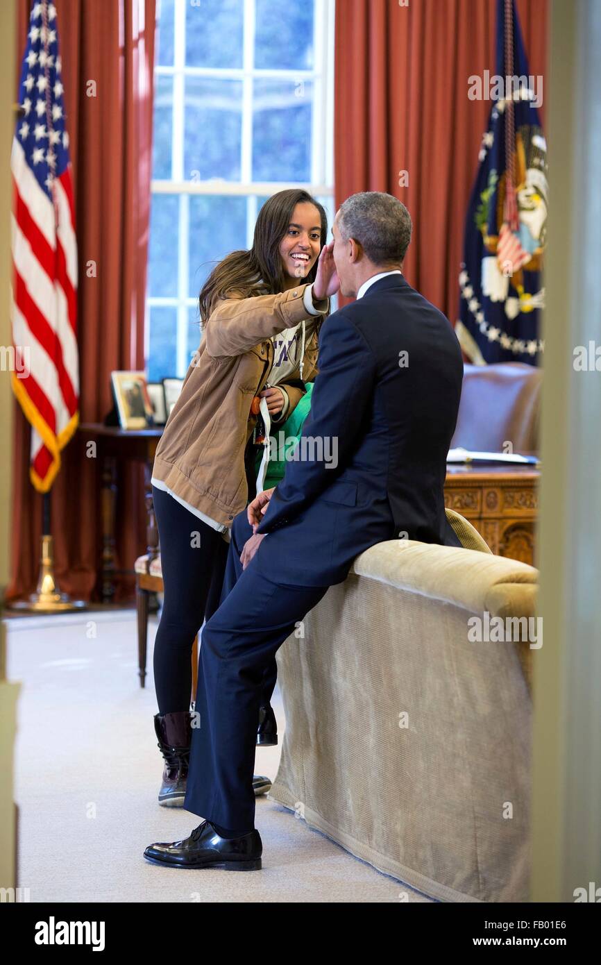 Daughter Malia Obama wipes something from the face of her father, U.S ...
