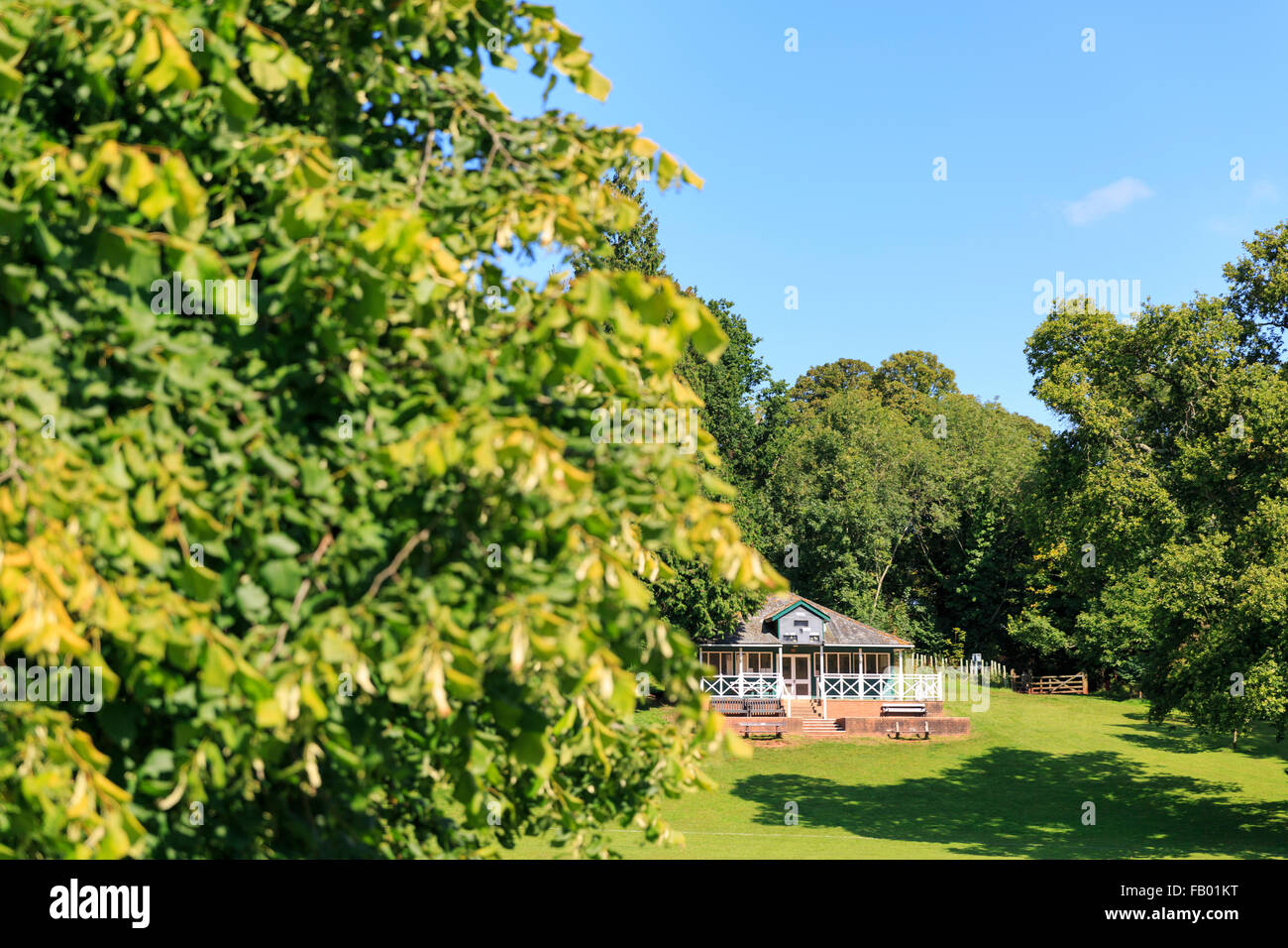 The small cricket pavilion on the sloping cricket green in Cockington ...