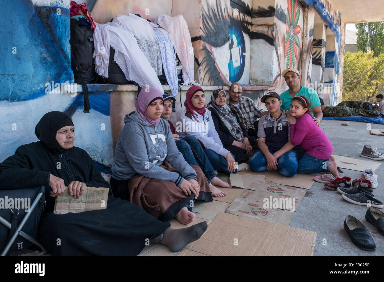 Family of Syrian refugees wait to board a Greek ferry after arriving on ...