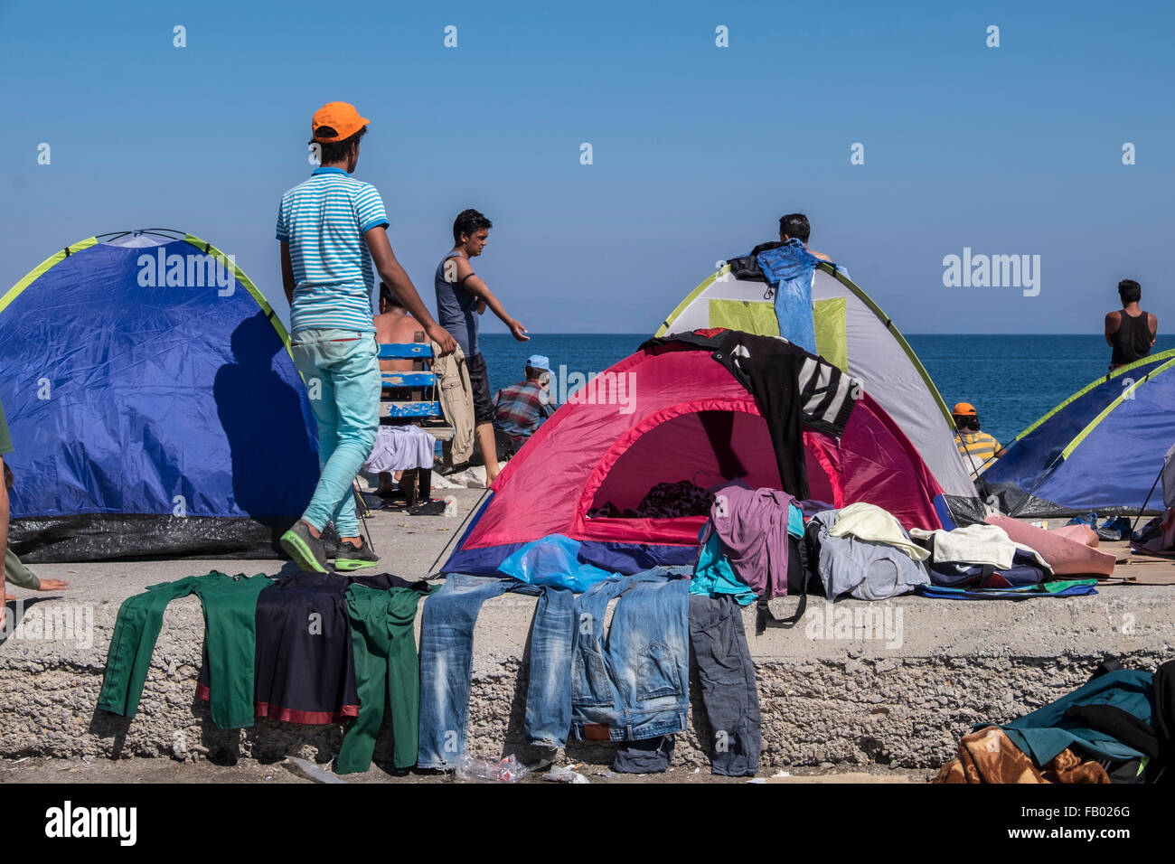 Refugees awaiting asylum processing sleep in tents in the harbor of ...