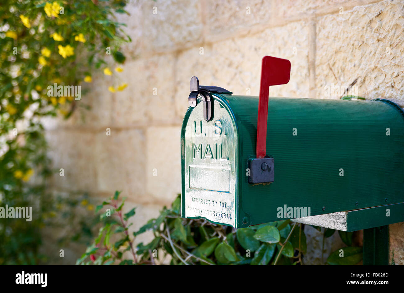 Green US post mail letter box with red flag raised up Stock Photo - Alamy