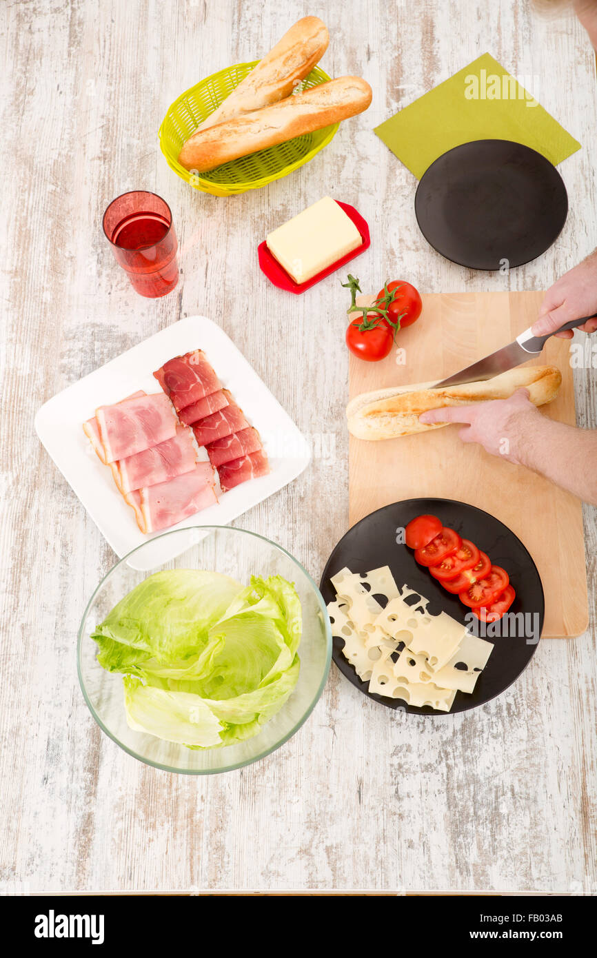 A young man preparing a sandwich in the kitchen Stock Photo - Alamy