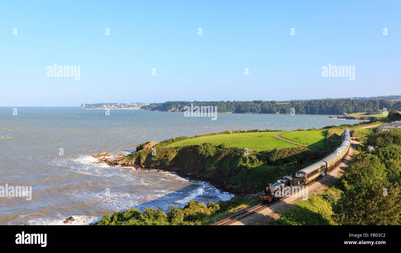 7820 Dinmore Manor hauls a train along the coast at Saltern Cove towards Paignton station on the ...