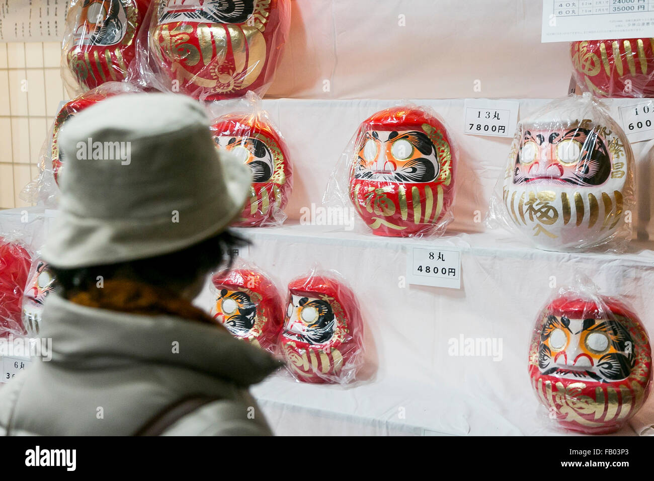 A woman looks at the Daruma dolls on sale at the Shorinzan Daruma ...