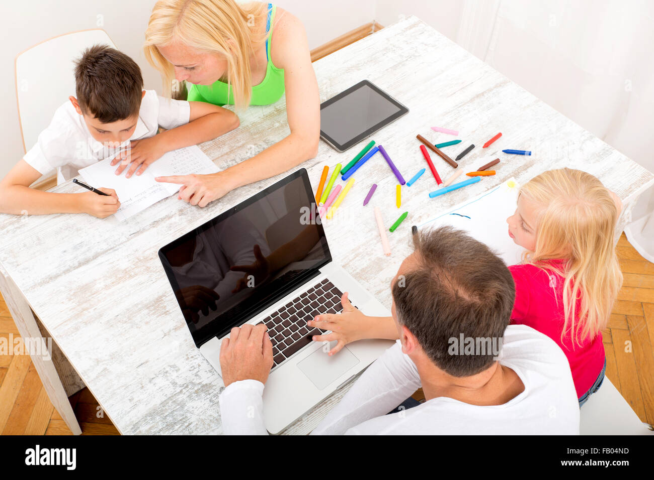 A family performing various activities at home Stock Photo - Alamy