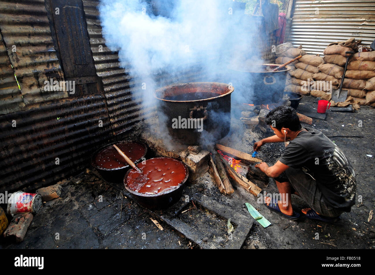 A local uses fan to fire up while cooking the molten raw hardened ...