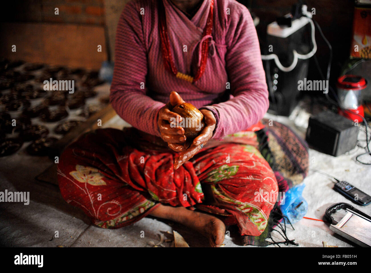A local puts ingredients on the molten raw hardened molasses or “Chaku ...