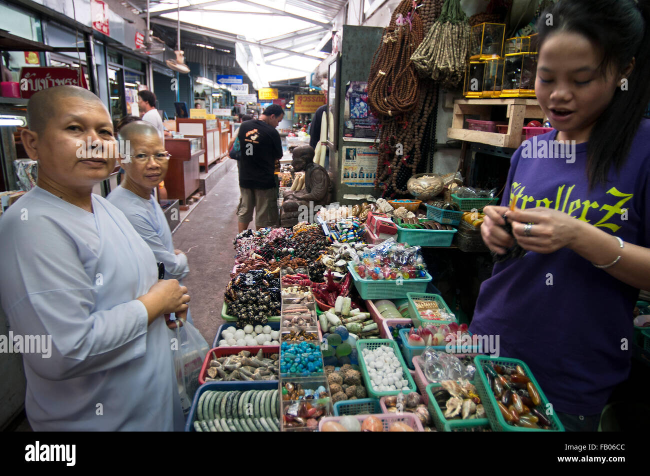 Buddhist nuns buying in Prachan Amulet Market in Bangkok, Thailand. The ...
