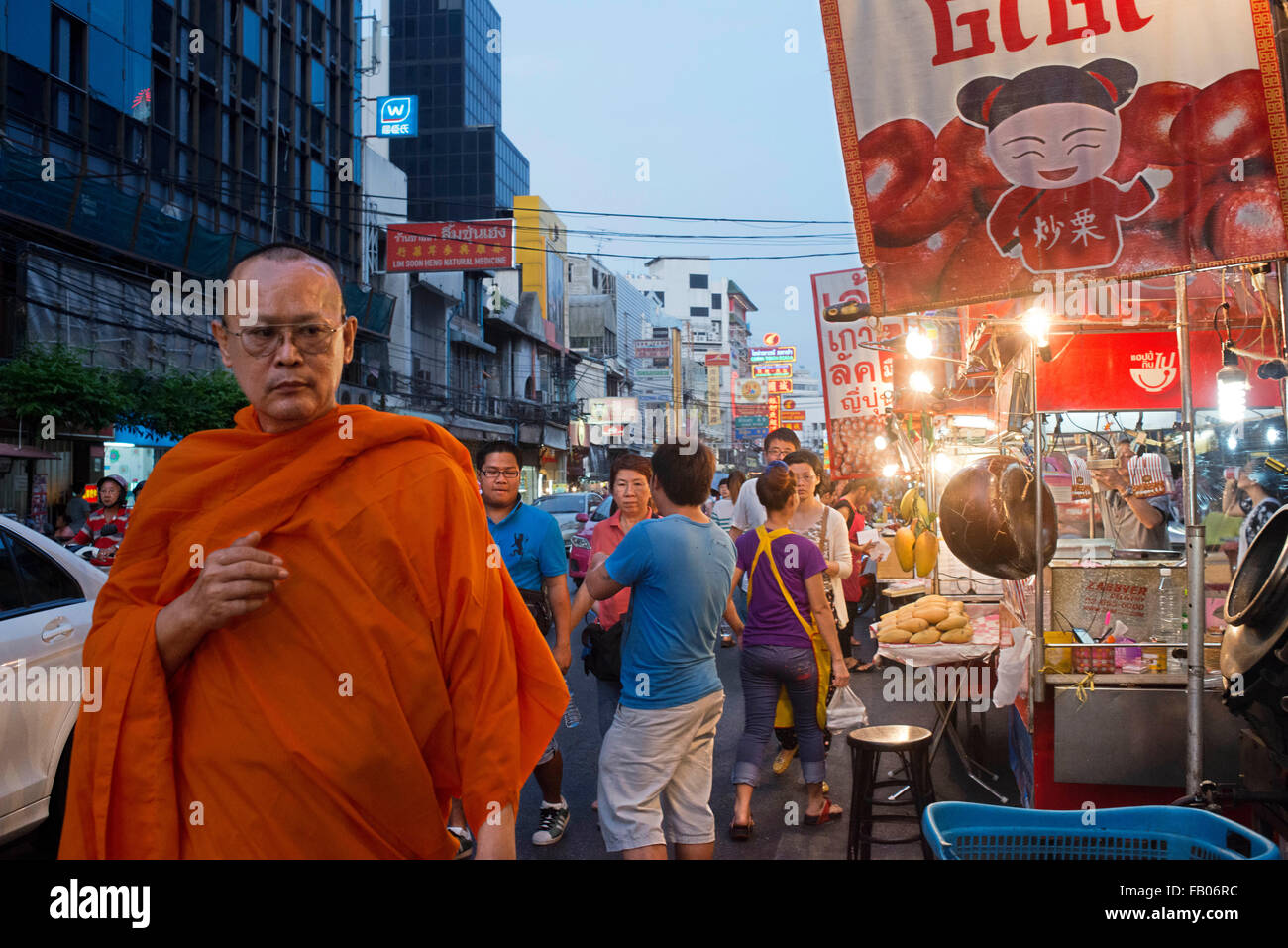 Montk in the street. View down Thanon Yaowarat road at night in central Chinatown district of ...