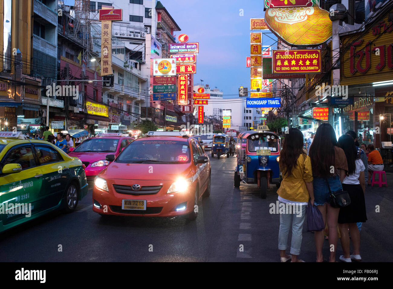 Taxis in the street. View down Thanon Yaowarat road at night in central Chinatown district of ...