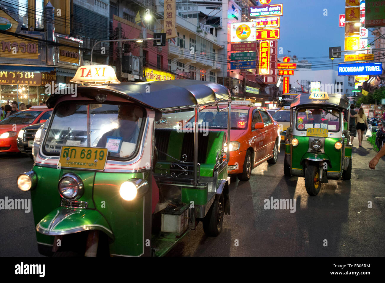 Tuk tuks taxi in the street. View down Thanon Yaowarat road at night in central Chinatown ...