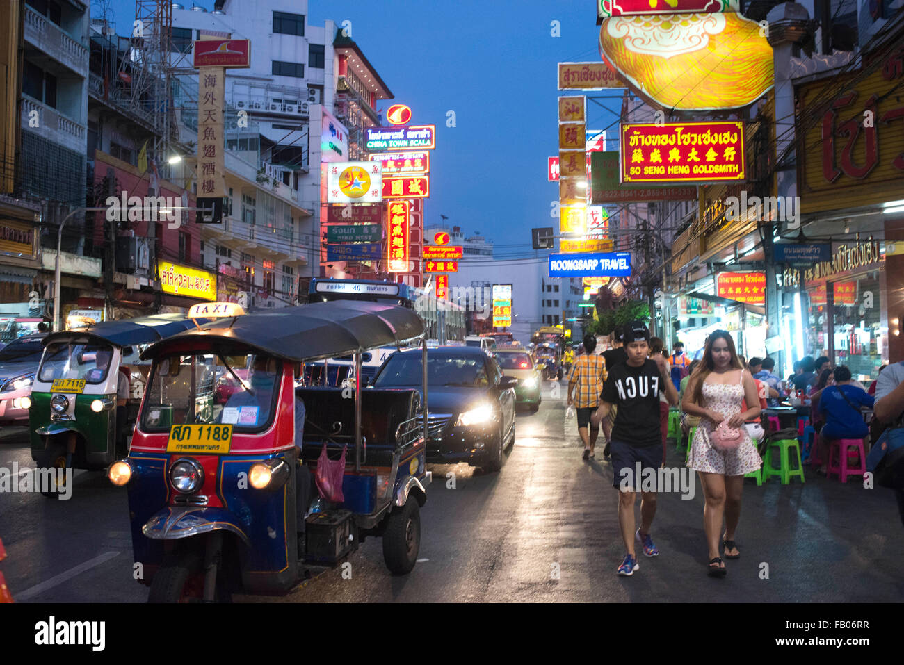 Tuk tuks taxi in the street. View down Thanon Yaowarat road at night in central Chinatown ...
