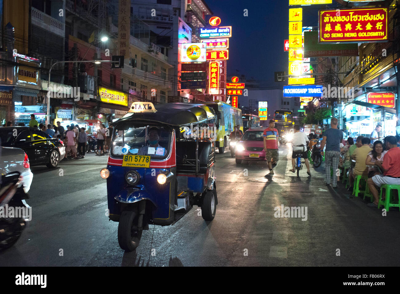 Tuk tuks taxi in the street. View down Thanon Yaowarat road at night in central Chinatown ...