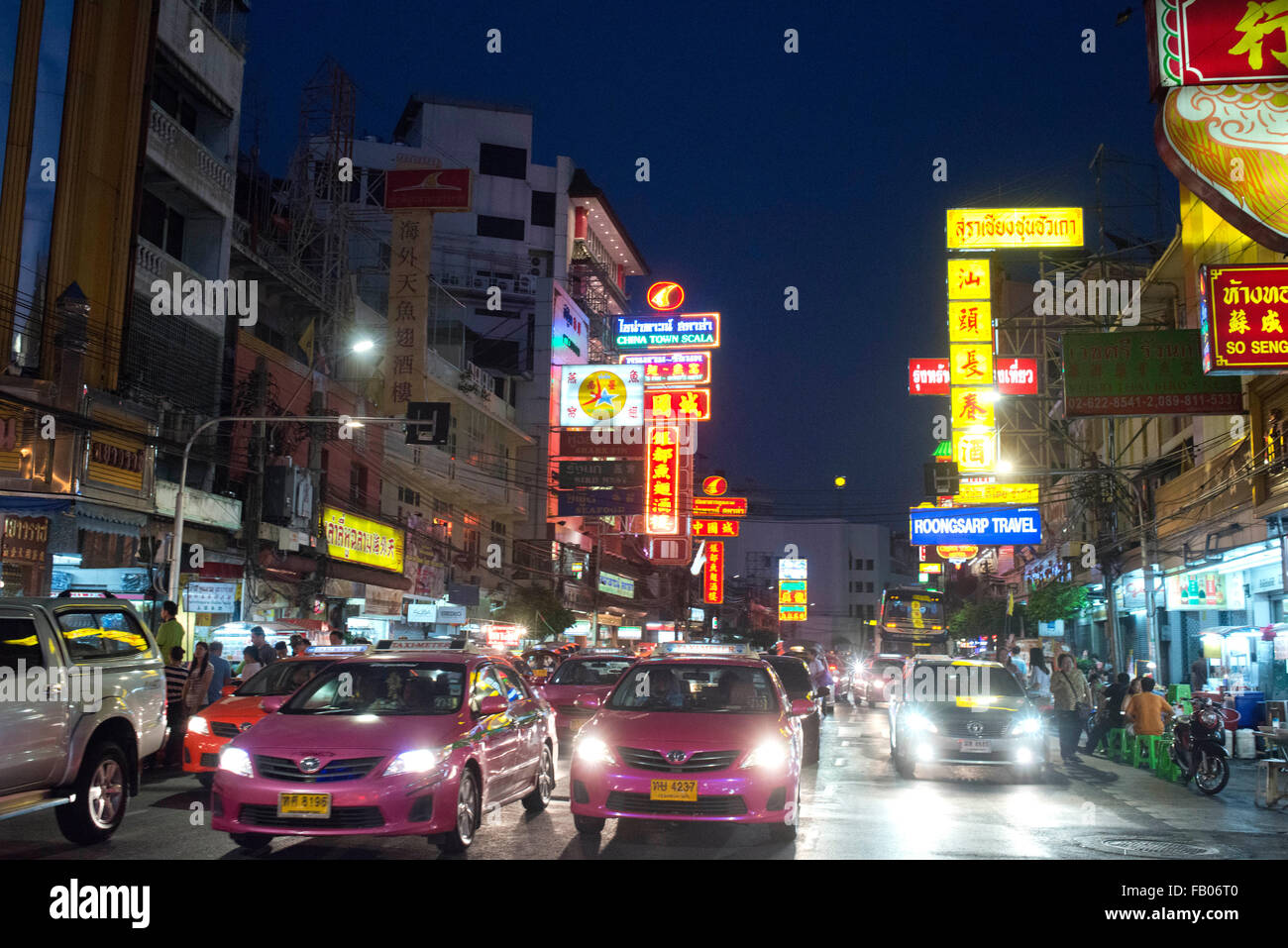 Taxis in the street. View down Thanon Yaowarat road at night in central Chinatown district of ...