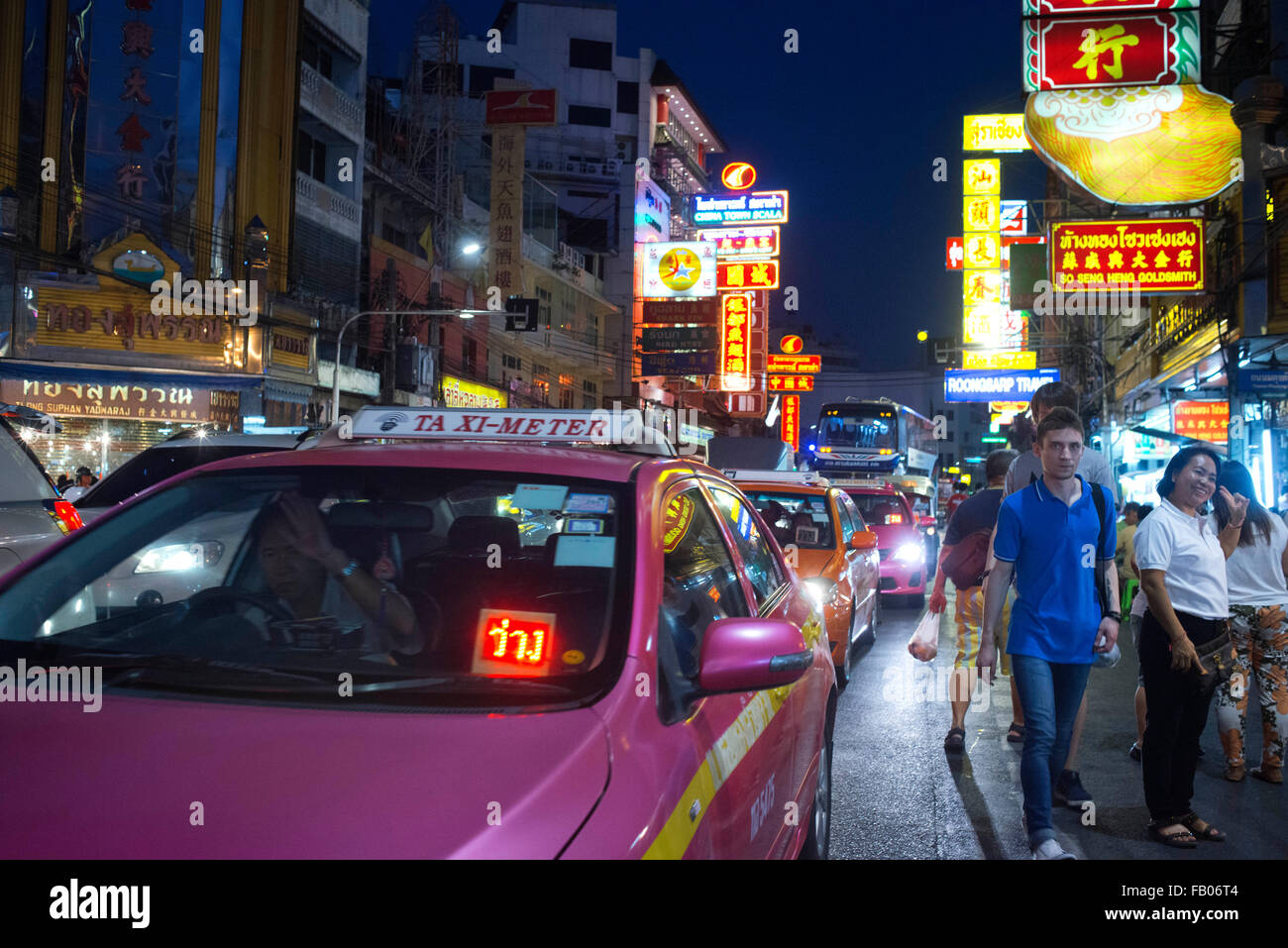Taxis in the street. View down Thanon Yaowarat road at night in central Chinatown district of ...