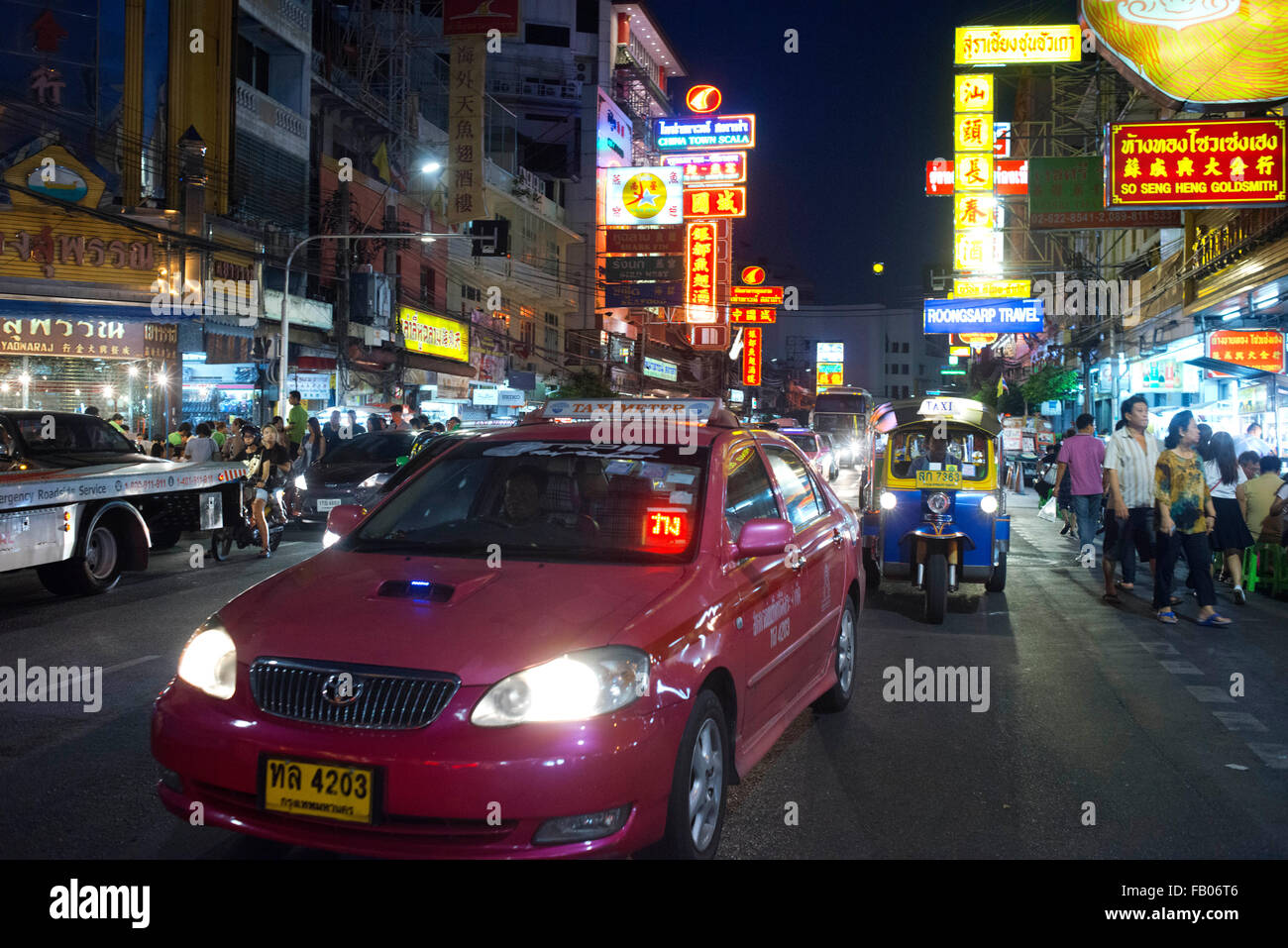 Taxis in the street. View down Thanon Yaowarat road at night in central Chinatown district of ...
