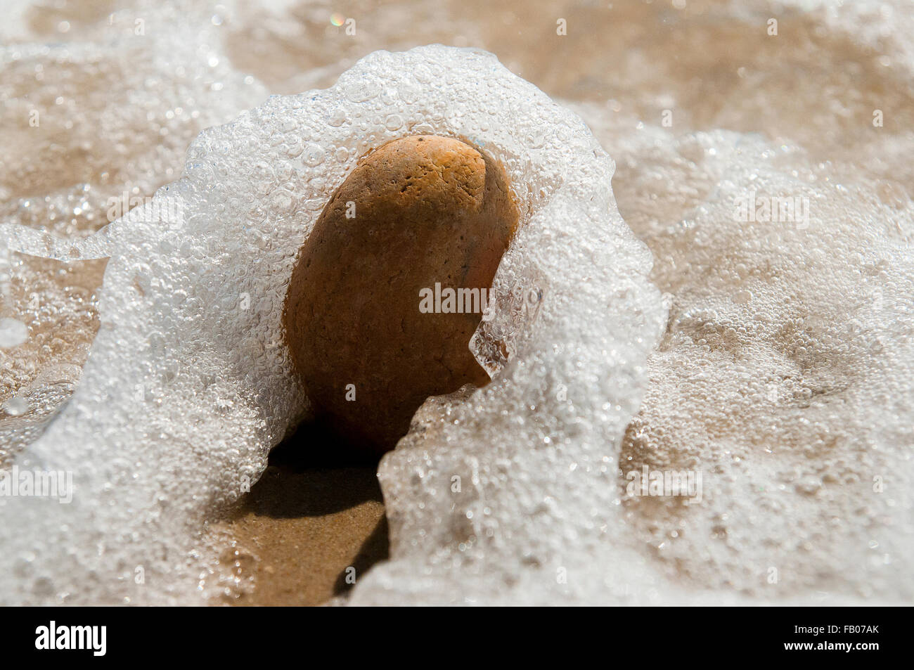 wave washing over pebble Stock Photo - Alamy